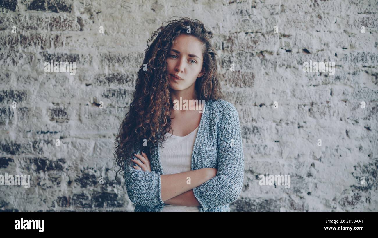 Portrait of angry young lady looking at camera, frowning and expressing ...