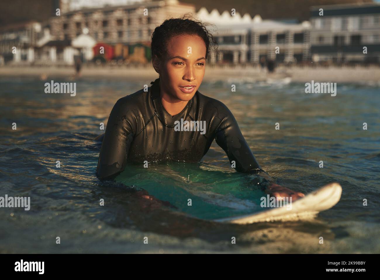 I surf waves not the internet. a beautiful young woman surfing in the ...
