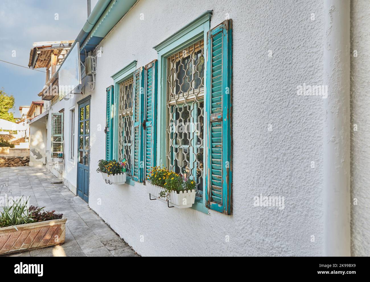 Wooden windows and shutters painted blue in house at sunset Stock Photo ...