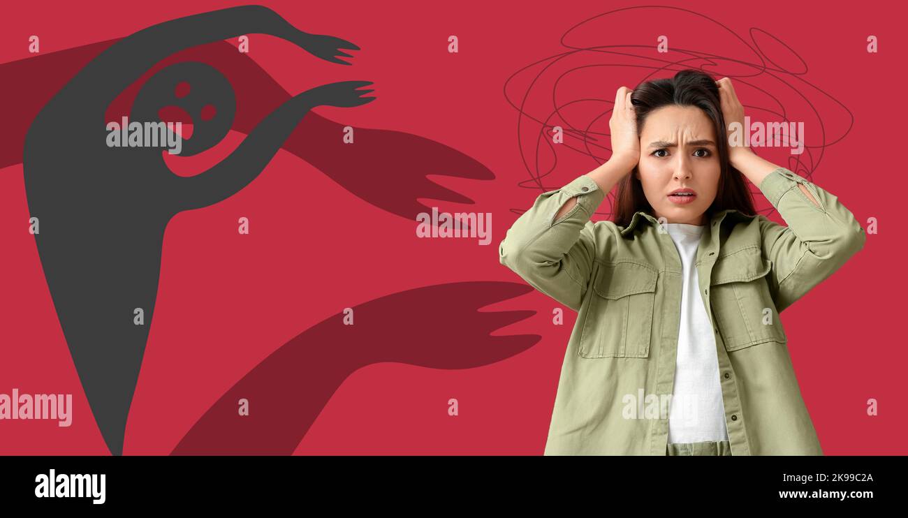 Scared young woman having panic attack and monsters on red background ...