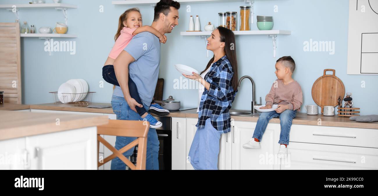 Young family washing dishes in kitchen Stock Photo - Alamy