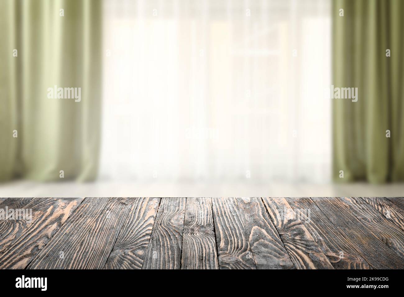Wooden table in interior of room with big window Stock Photo - Alamy
