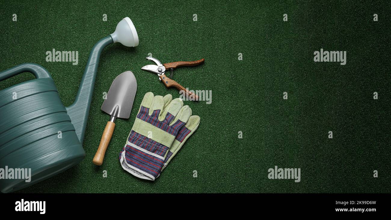 Gardening tools on green background with space for text Stock Photo - Alamy