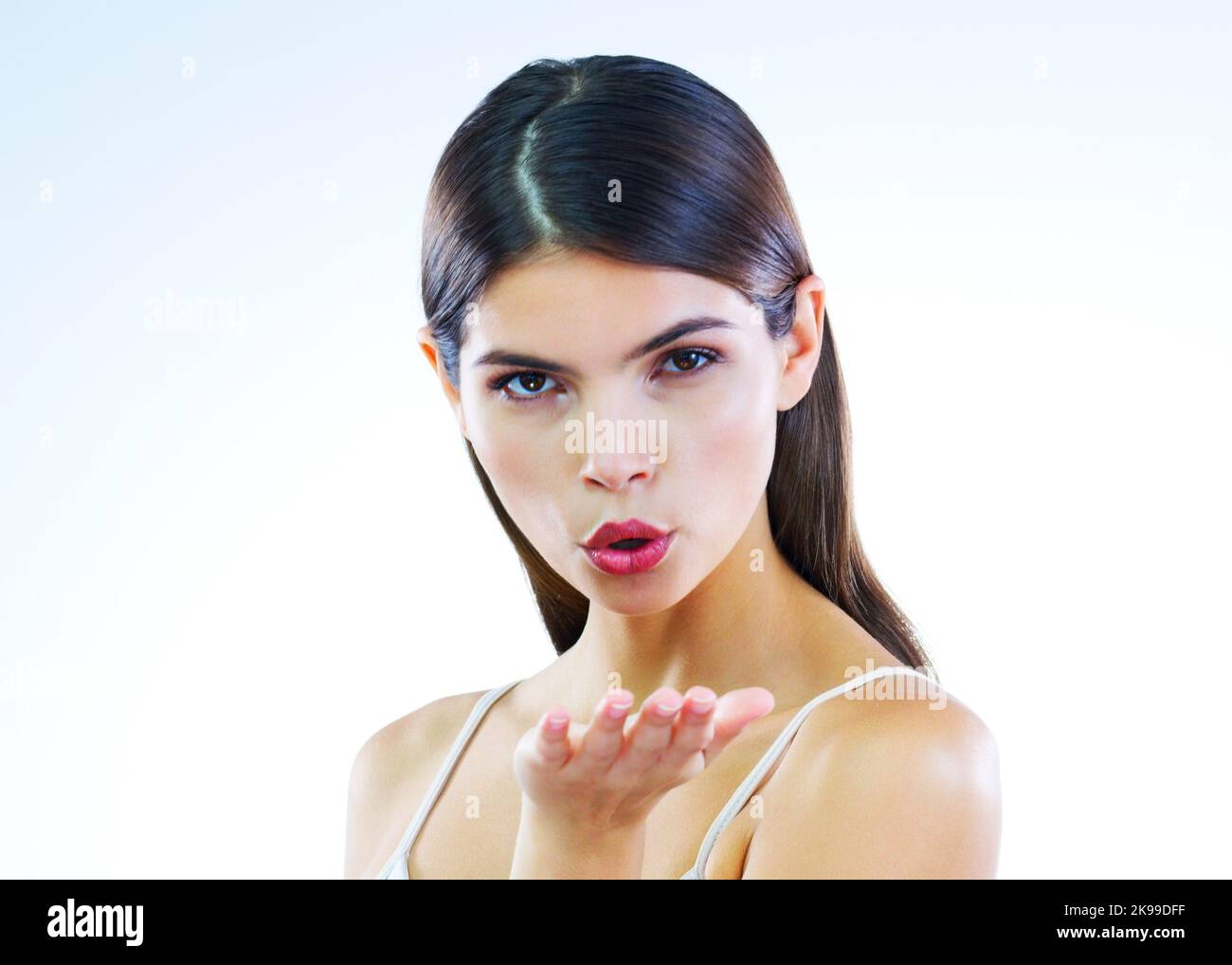 All it takes is one kiss. a beautiful young woman blowing kisses ...