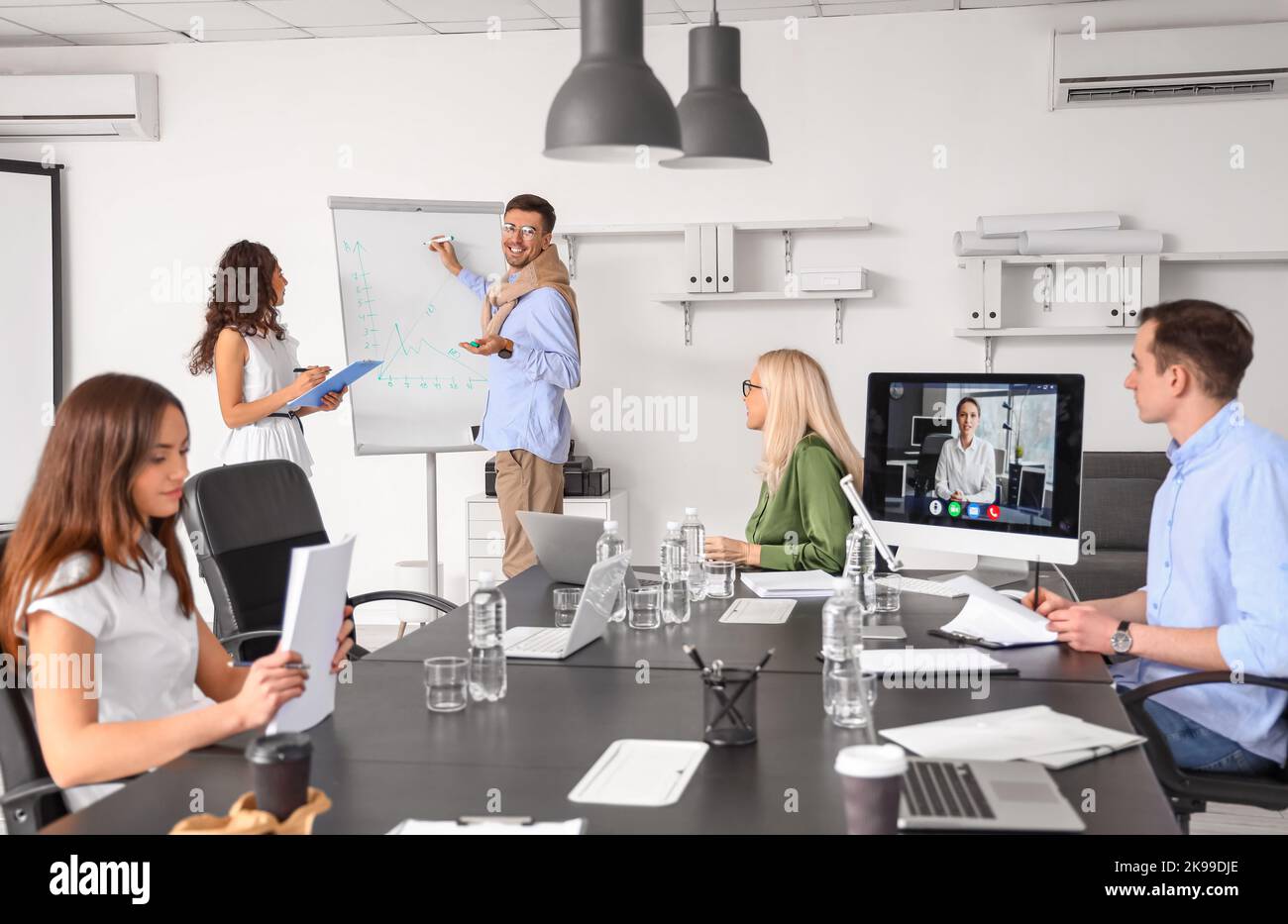 Business colleagues giving presentation during meeting in office Stock ...
