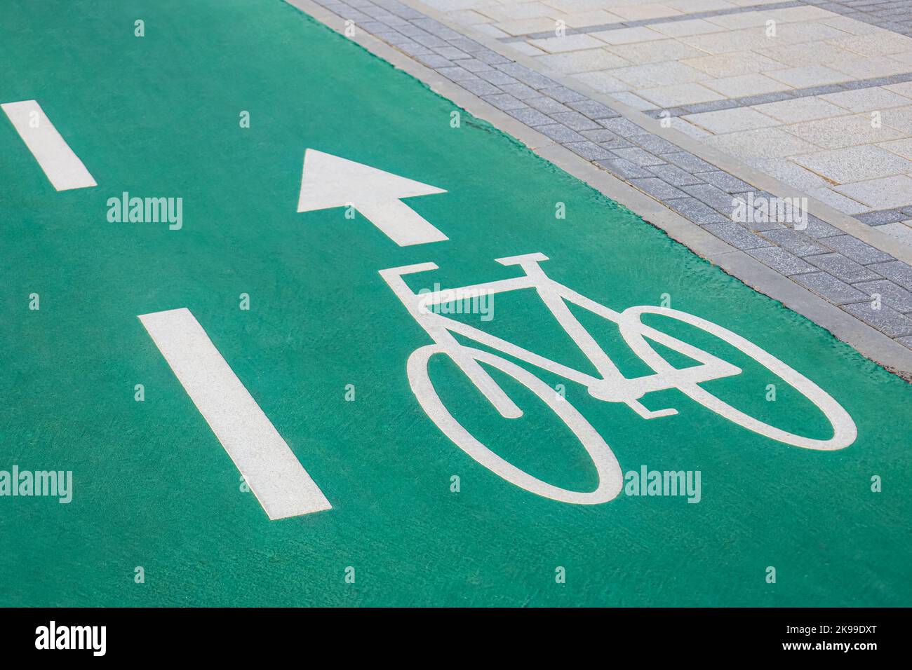 Bicycle sign with direction arrow outdoors Stock Photo - Alamy