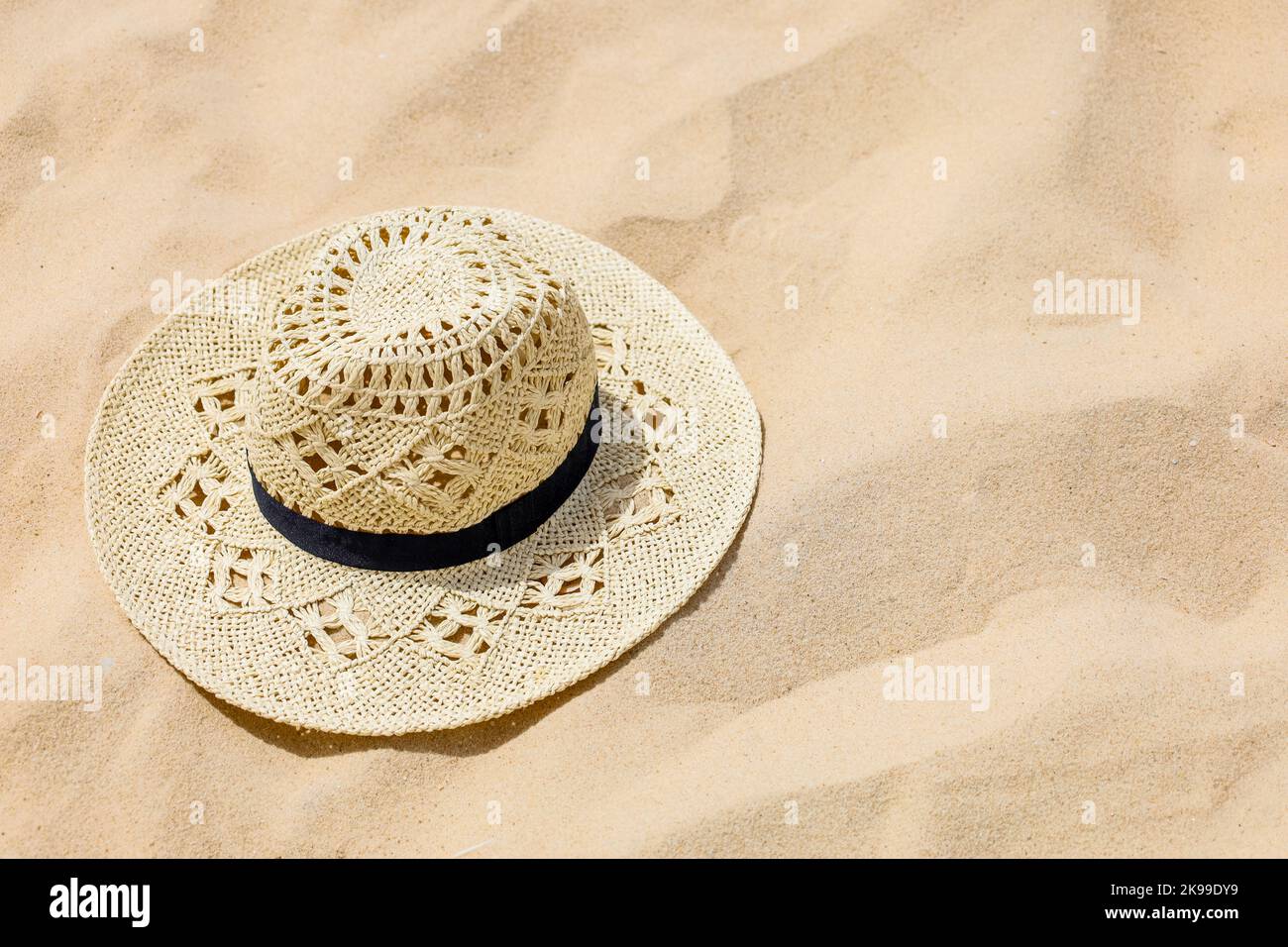 Stylish straw hat on sand Stock Photo - Alamy