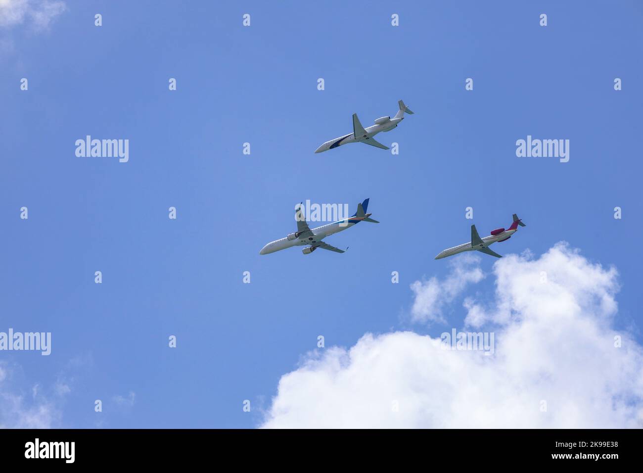 Modern airplanes flying in blue sky Stock Photo - Alamy