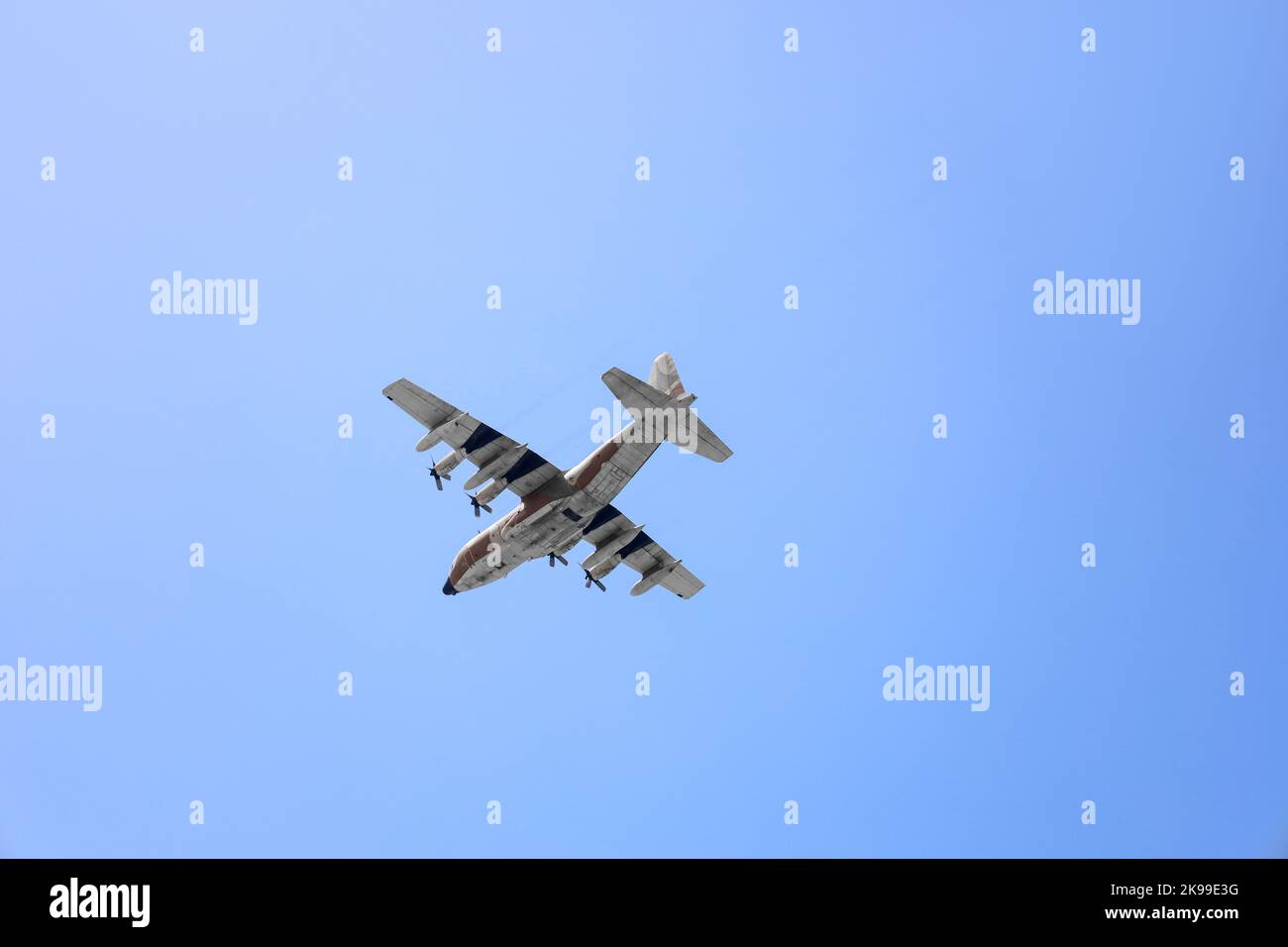 Modern airplane flying in blue sky Stock Photo - Alamy