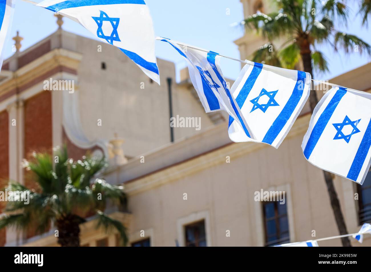 Flags of Israel hanging on city street, closeup Stock Photo - Alamy