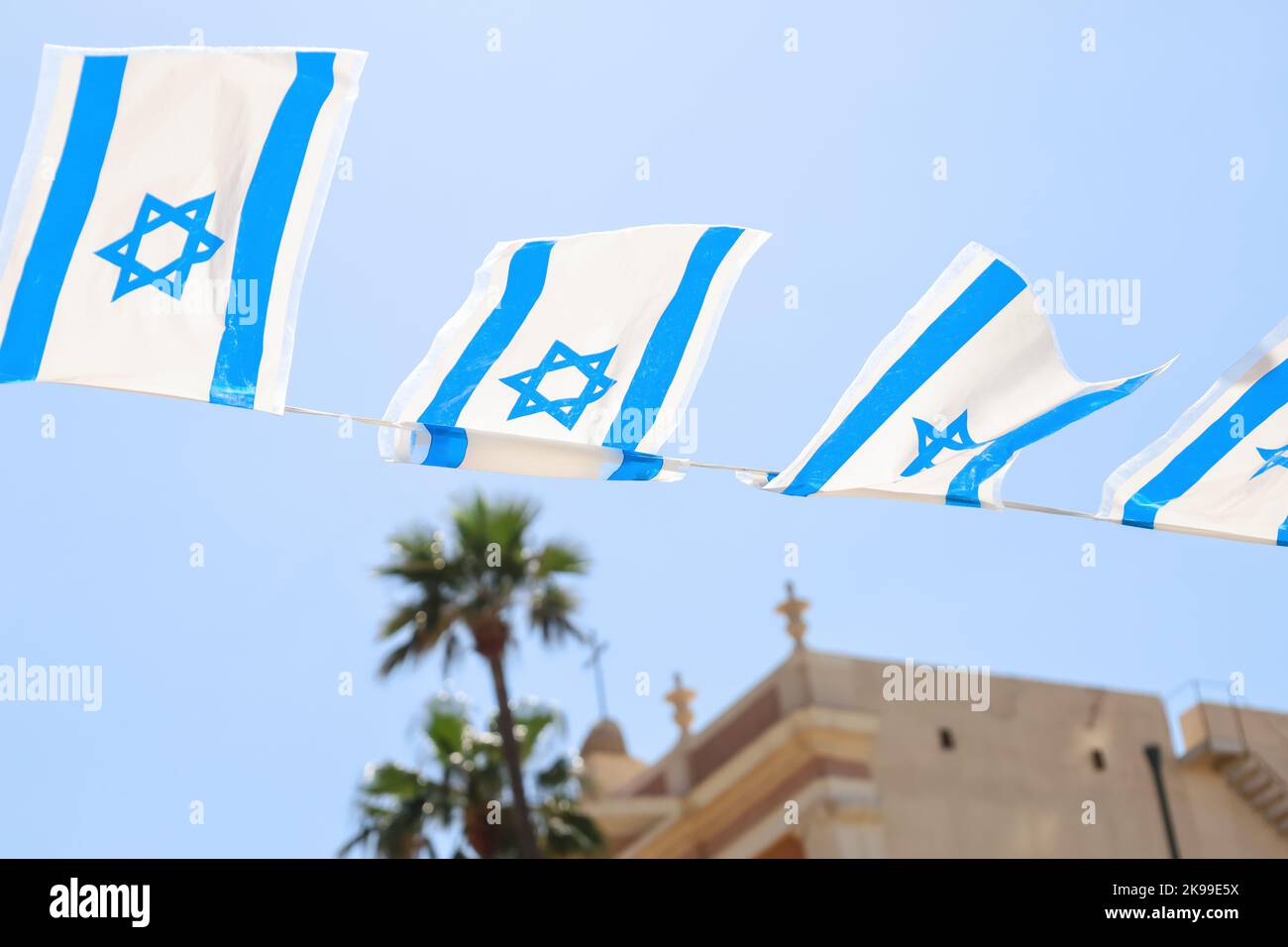 Flags of Israel hanging on city street, closeup Stock Photo - Alamy