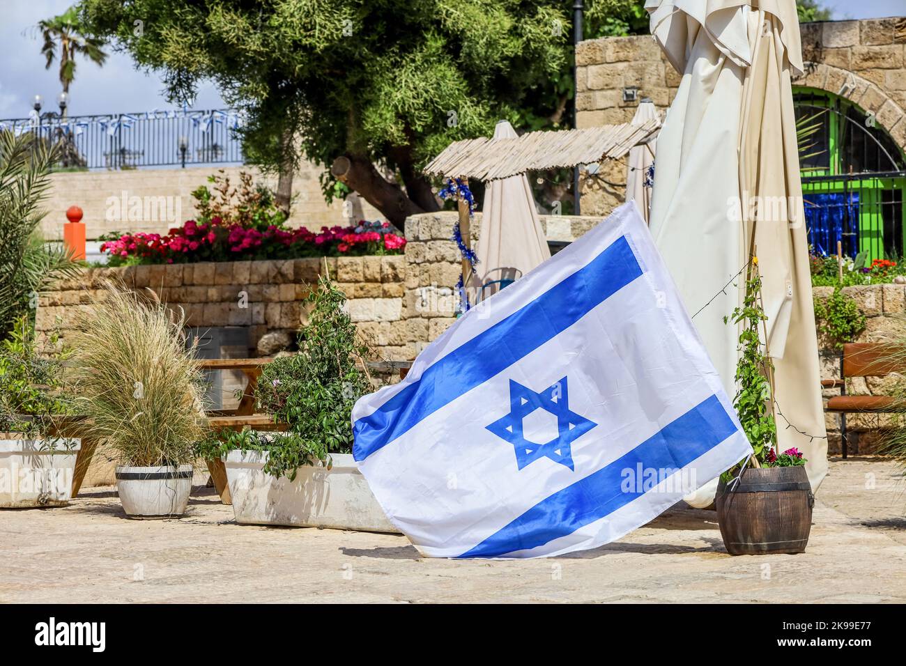 Flag of Israel hanging on city street Stock Photo - Alamy