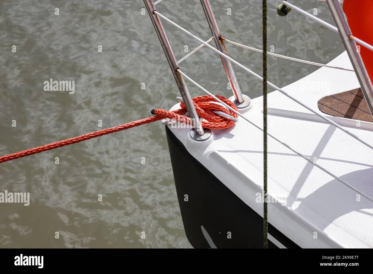 Modern yacht tied with rope at pier, closeup Stock Photo - Alamy