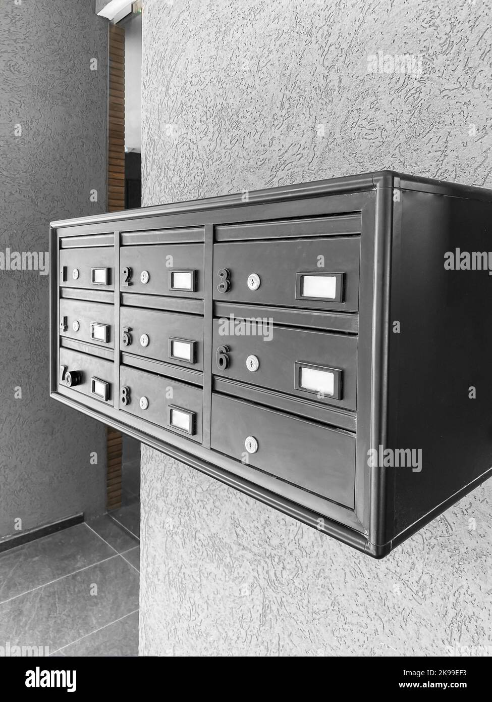 Modern mailboxes on grey wall in residential building Stock Photo - Alamy