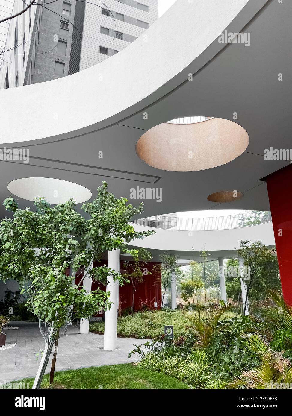 Modern building with big hall and plants Stock Photo - Alamy