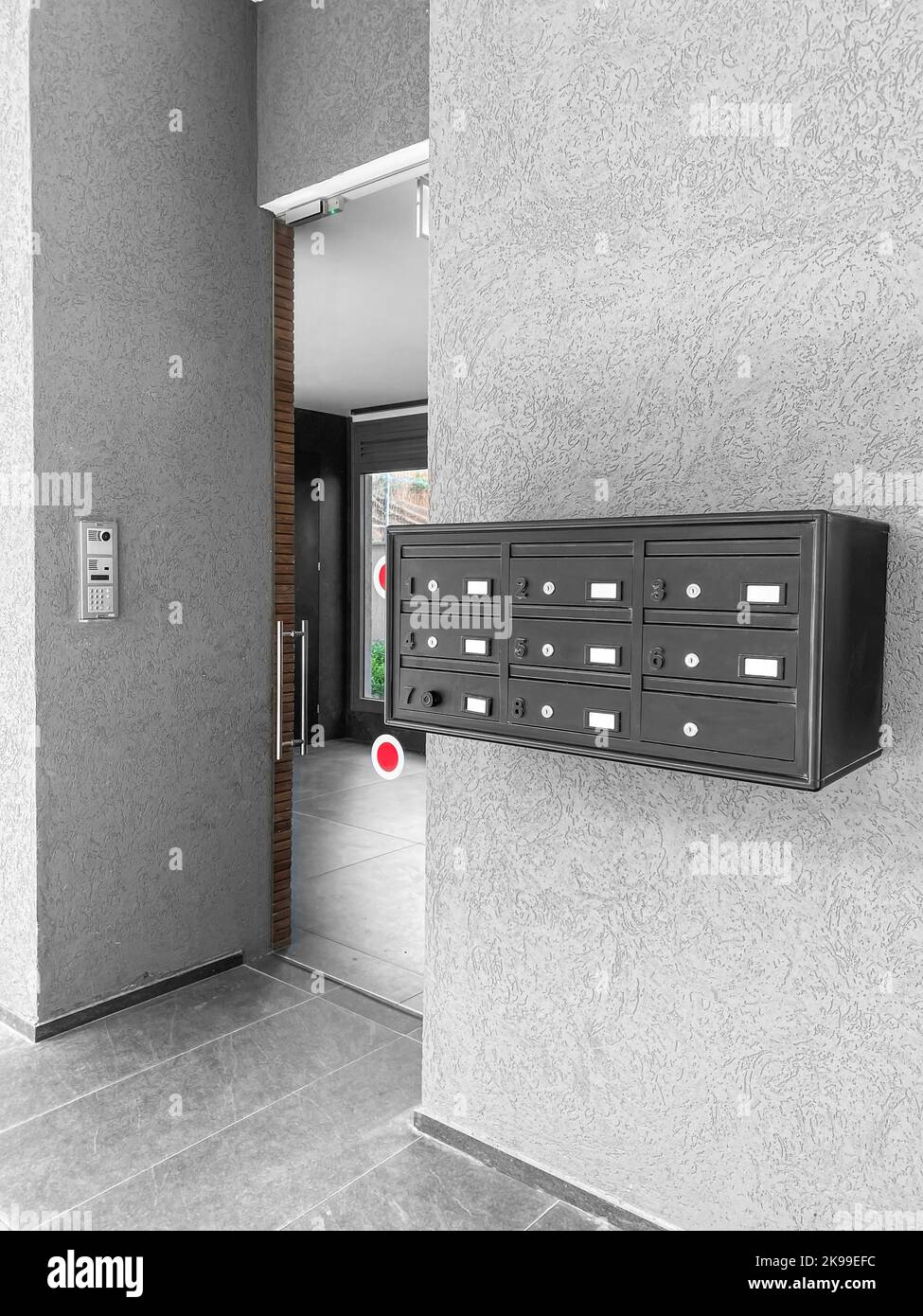 Modern mailboxes on grey wall in residential building Stock Photo - Alamy