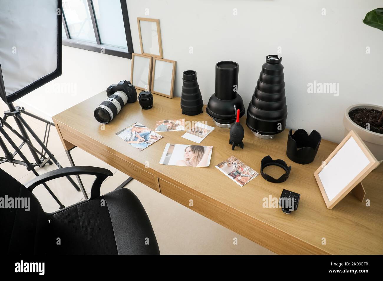 Photographer's workplace with equipment, blank frames and pictures in ...