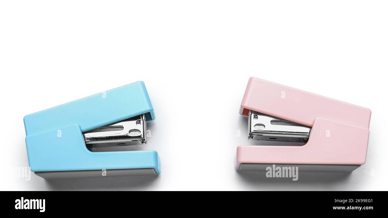 Two colorful staplers isolated on white background Stock Photo - Alamy