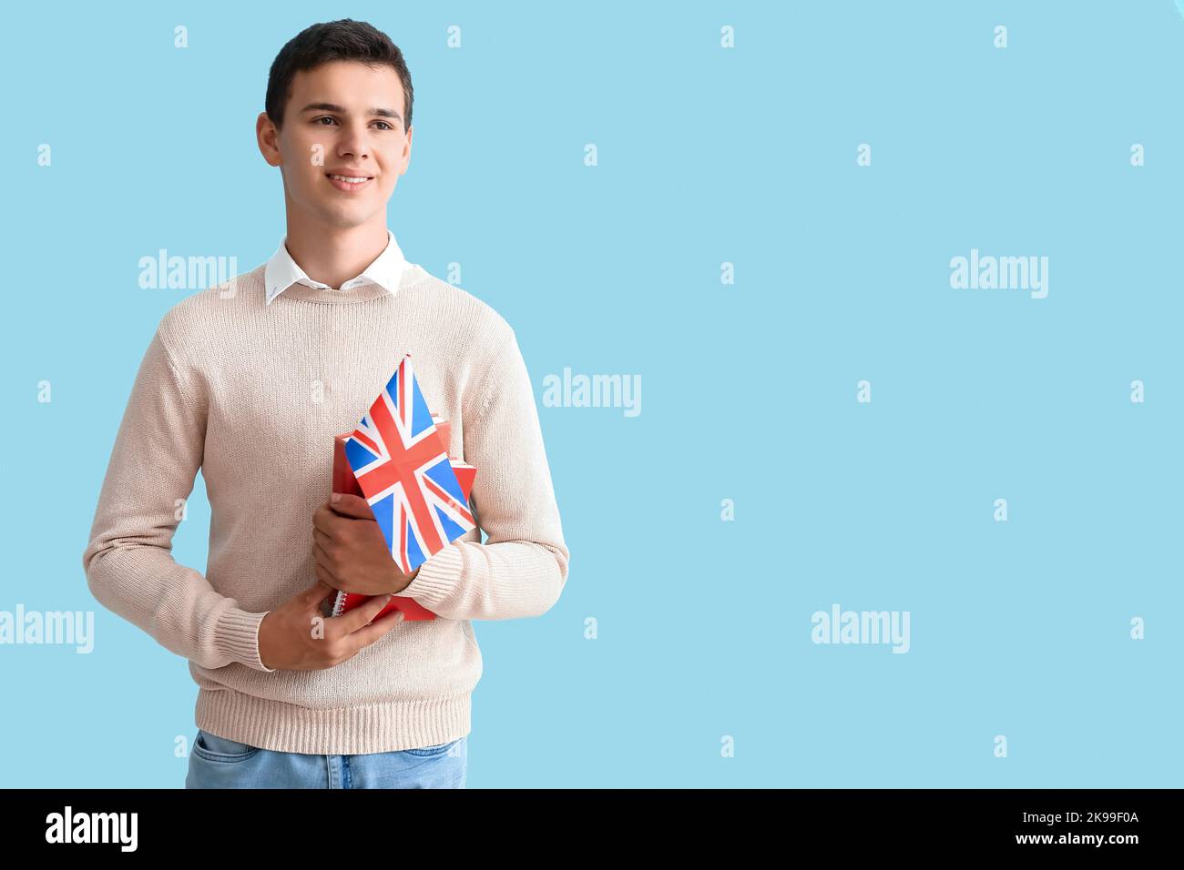 Teenage boy with UK flag on blue background Stock Photo - Alamy