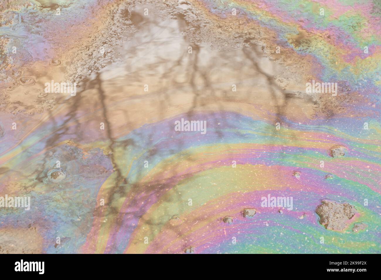 gasoline spilled on the road in a puddle of colorful water Stock Photo ...