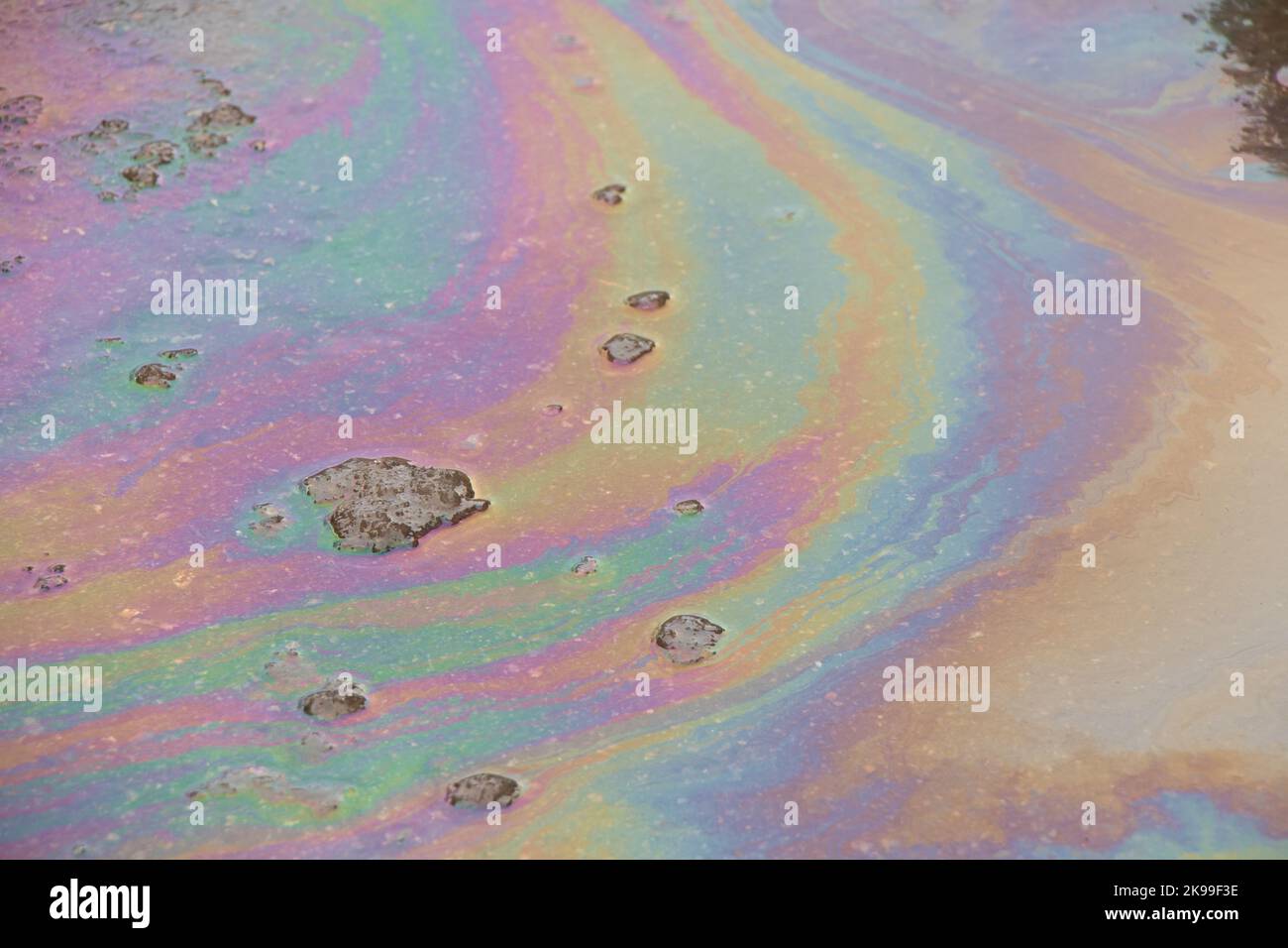 gasoline spilled on the road in a puddle of colorful water Stock Photo ...