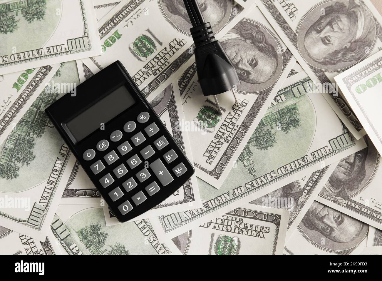 Calculator and plug on dollar banknotes. Heating season concept Stock ...