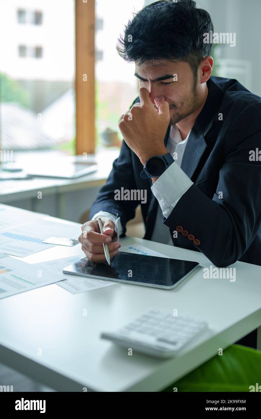 Male business owners use tablets to monitor financial budgets to plan ...