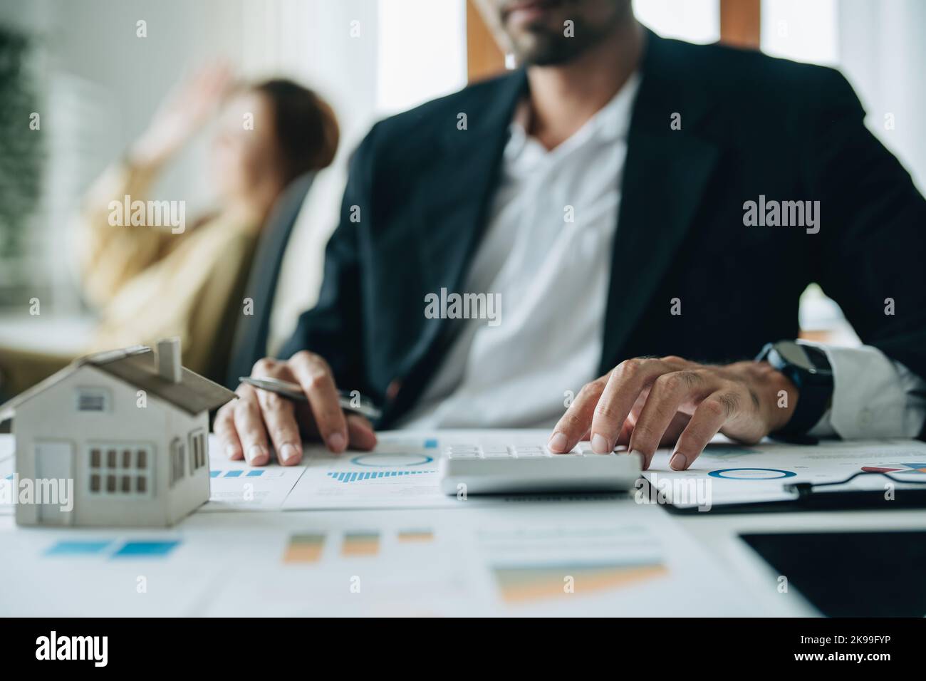 Bank loan workers are using calculators to calculate home loan interest ...