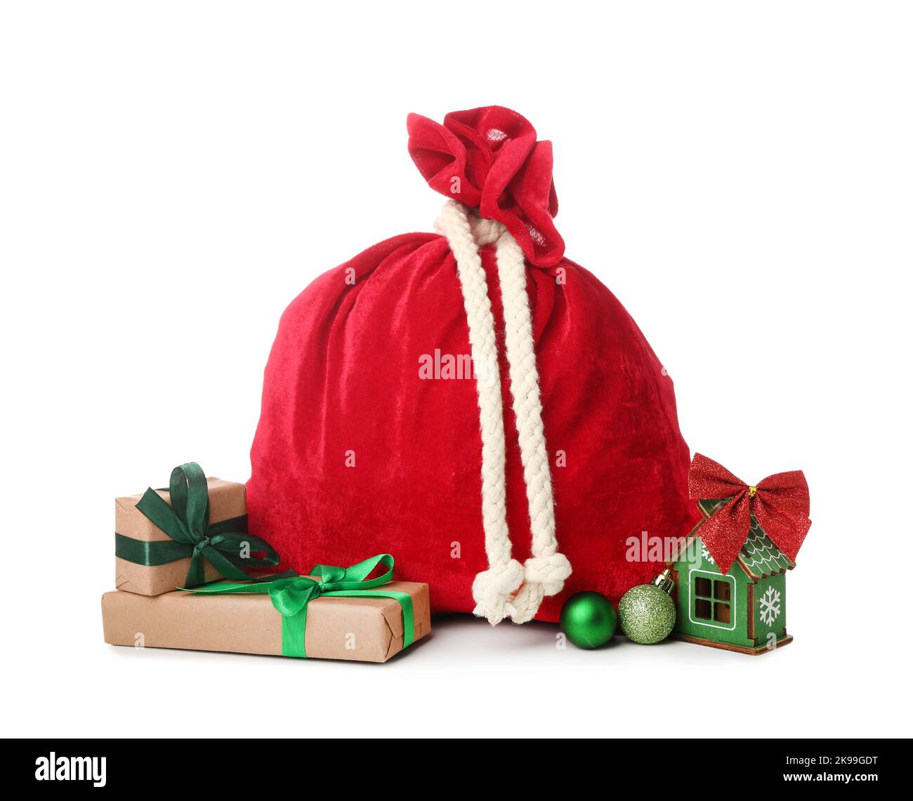 Red Santa Claus bag with decorations and gifts on white background ...