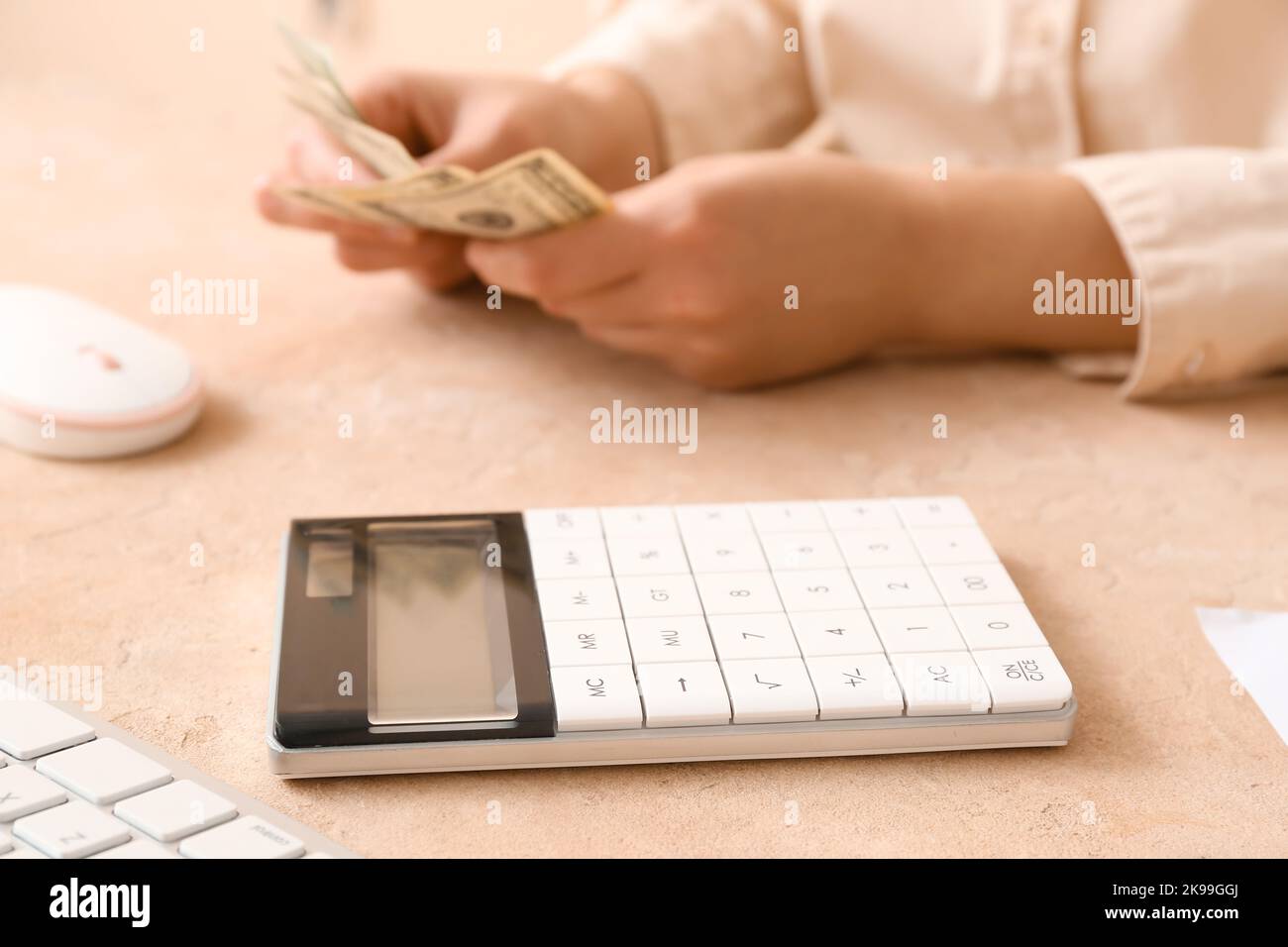 Calculator on beige table, closeup. Budget concept Stock Photo - Alamy