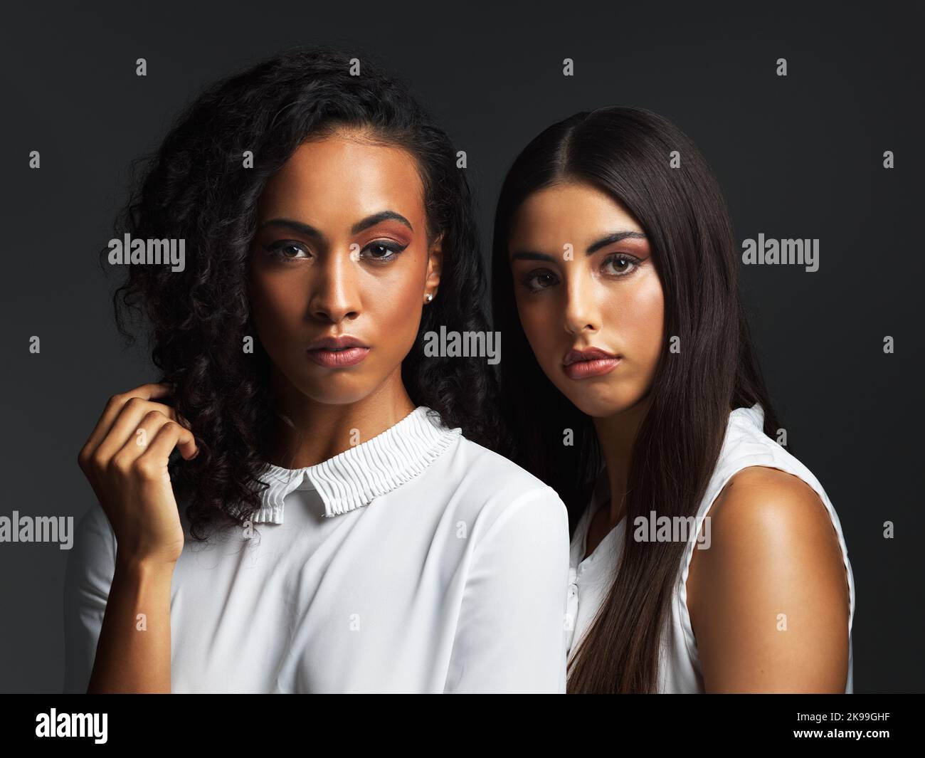 Women rule the world. Portrait of two attractive young women wearing ...