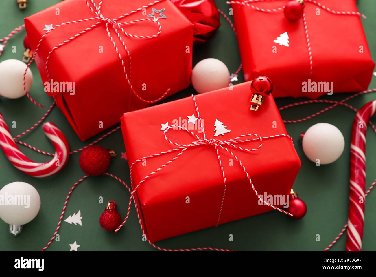Beautiful Christmas gifts and decorations on green background, closeup ...
