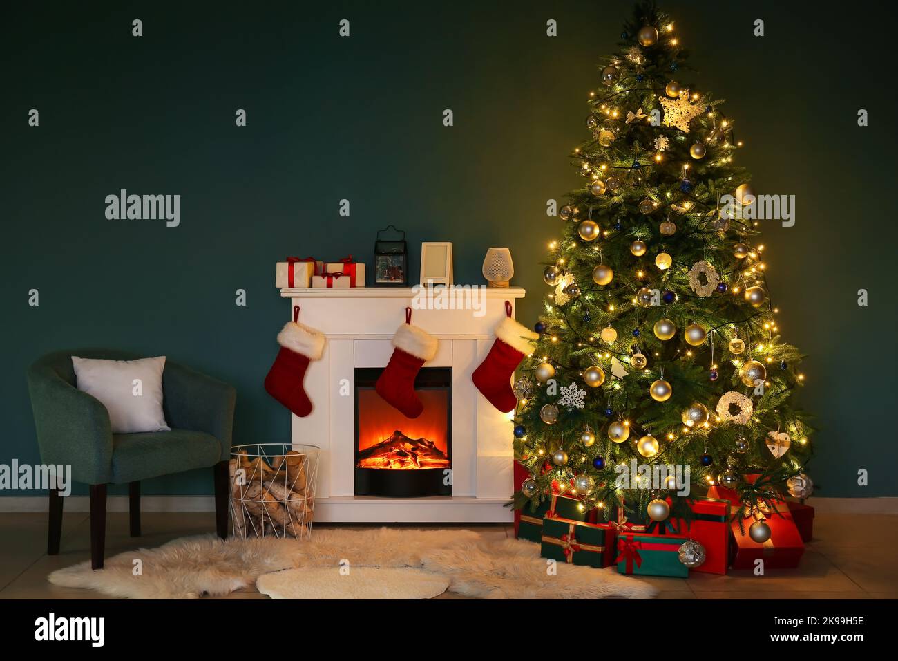 Interior of dark living room with glowing Christmas tree and fireplace ...