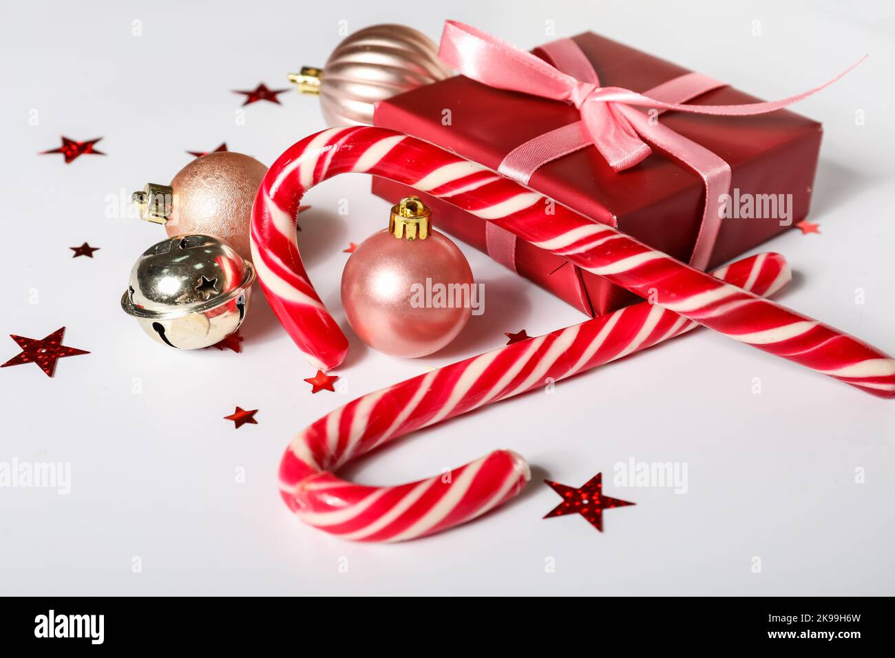 Candy canes, Christmas gift and decorations on white background ...