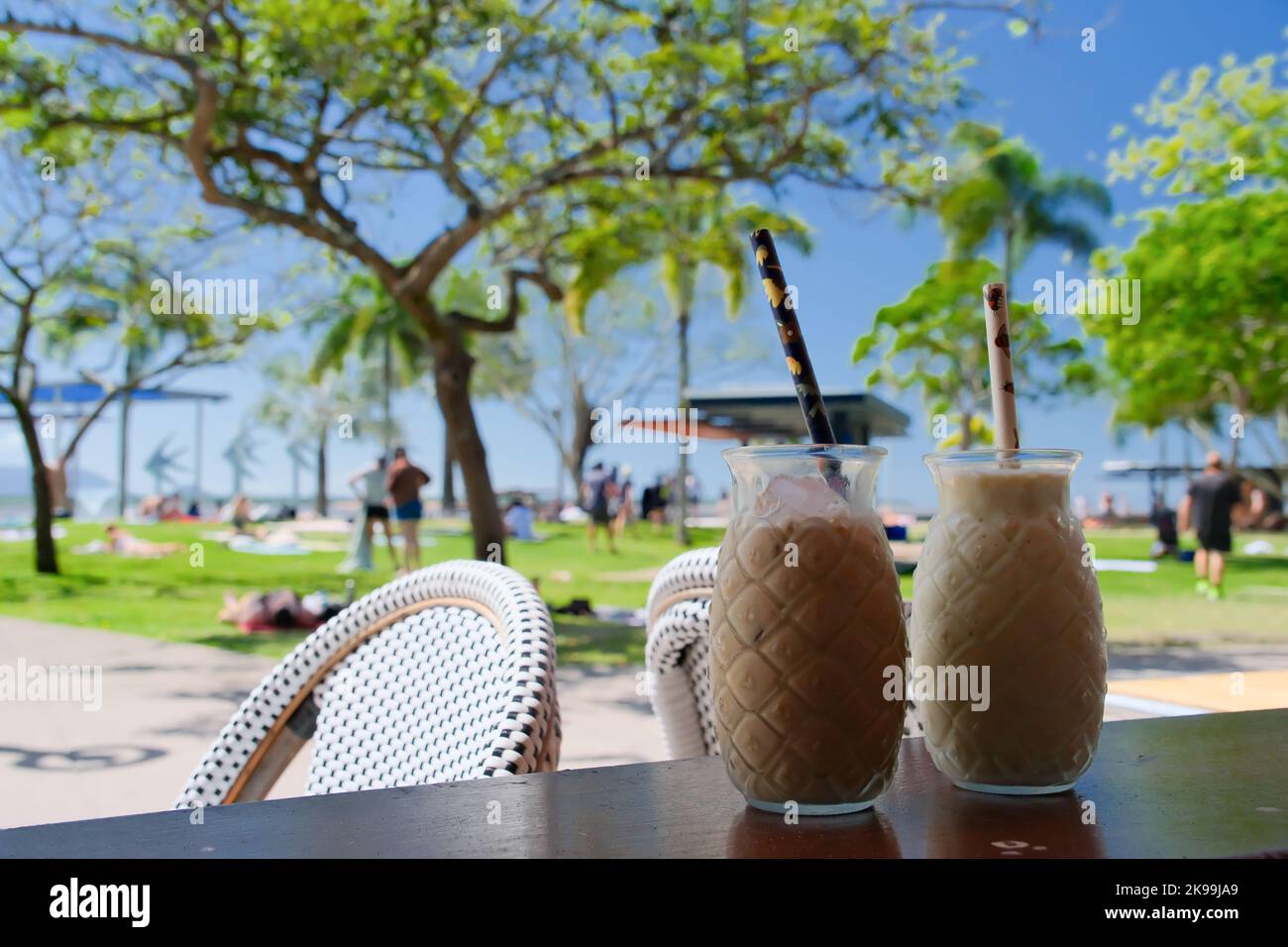Coffee cups on a table at beautiful sunny day in Cairns city esplanade ...