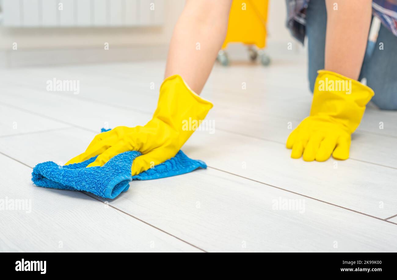 Deep Cleaning service. Professional cleaner washing white floor in ...