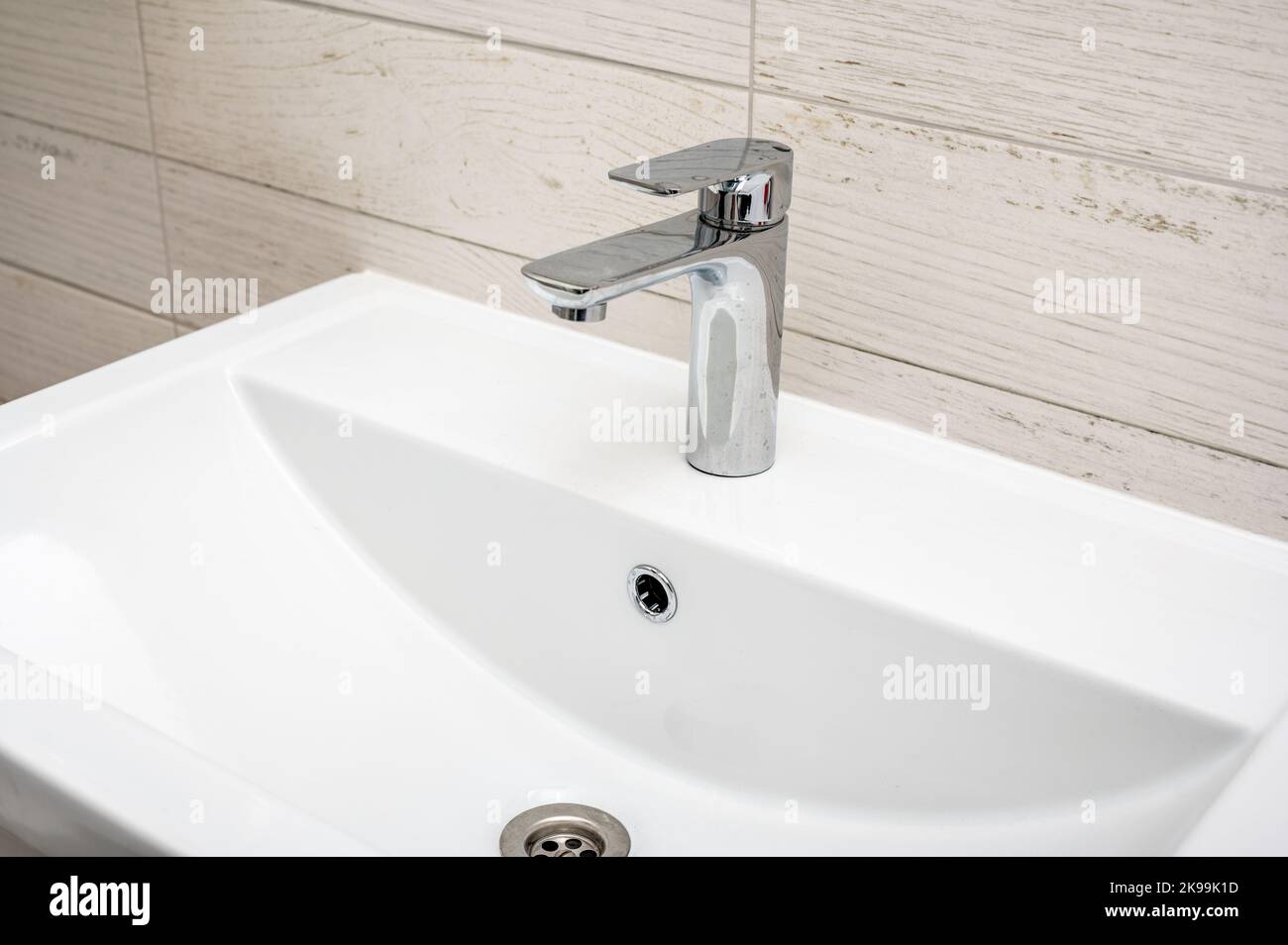 Sink in bathroom. Modern bathroom faucet. Bathroom interior with white ...