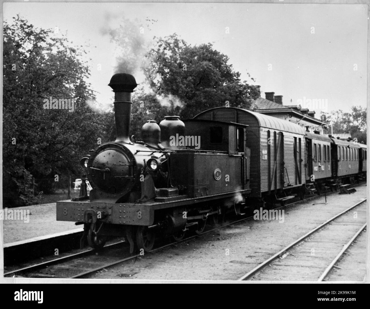 Steam locomotive 8 with freight wagon and passenger cars at the railway ...