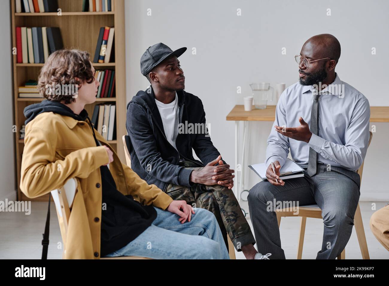 African coach talking to students and explaining them material at class ...