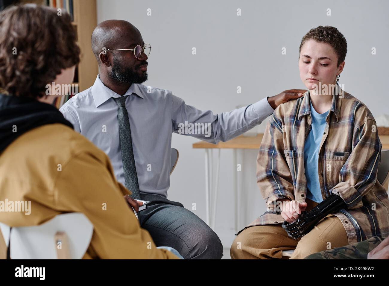 Young girl with disability talking about her problems to people at ...
