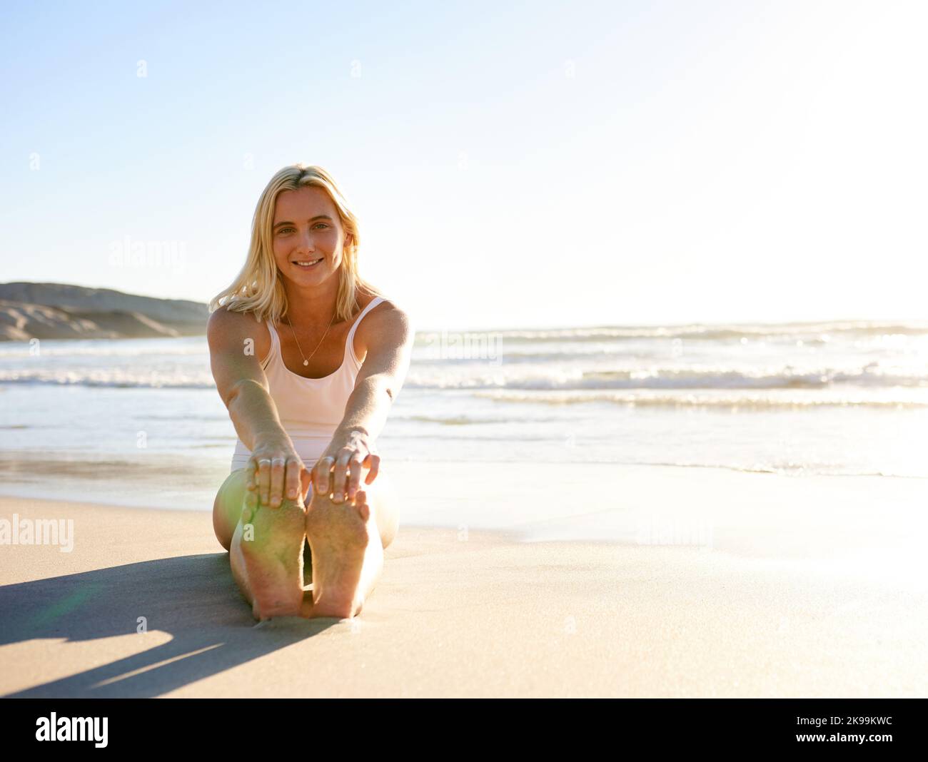 Stretching before doing yoga. Full length shot of an attractive young ...