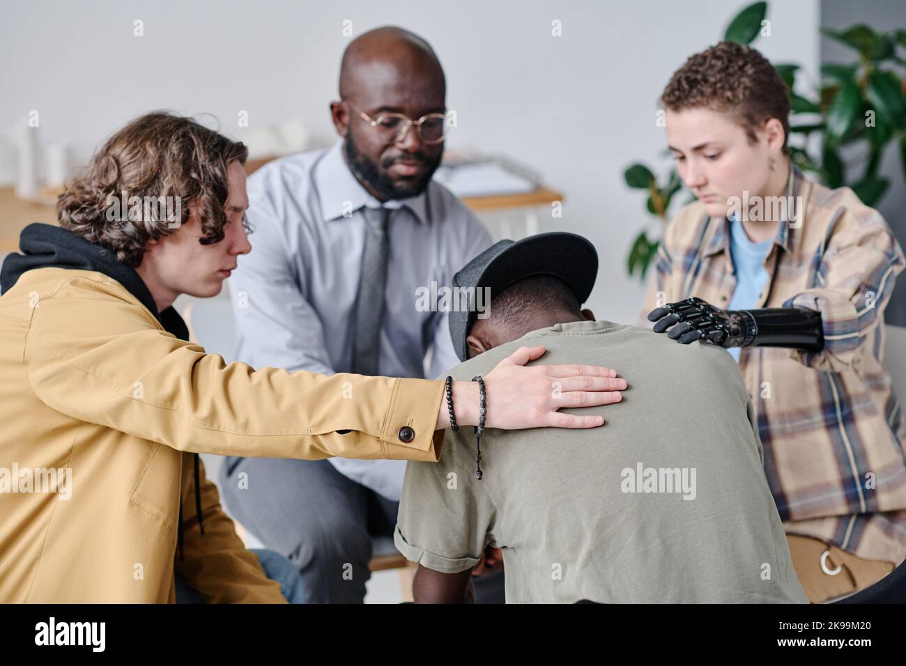 African teenage boy talking about his problems to people while they ...