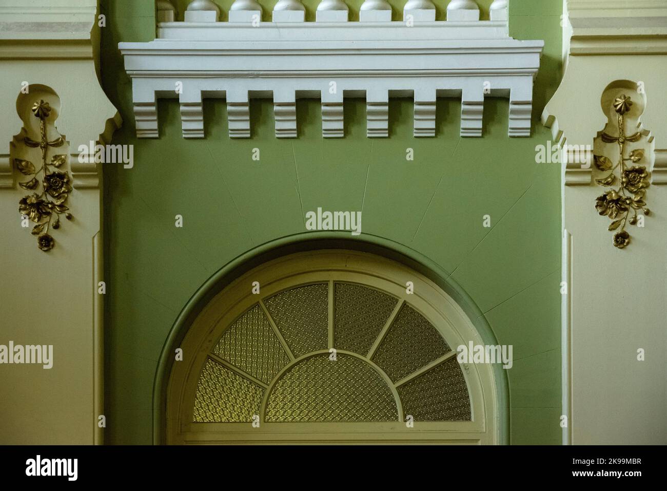 A green wall with an arched window Stock Photo - Alamy