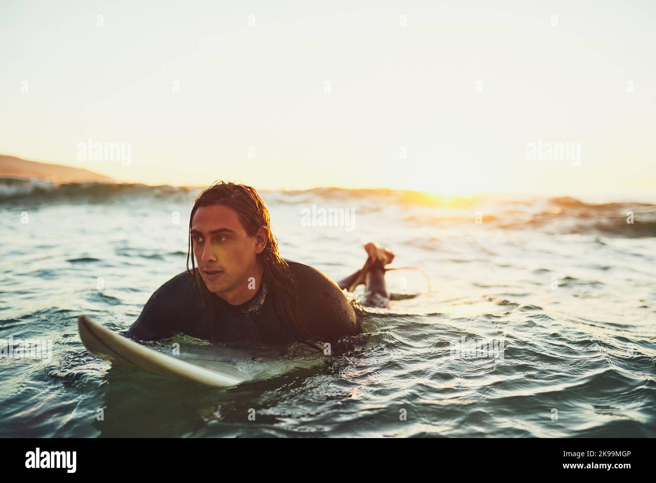 Rise with the tide and go with the flow. a young man paddling on a ...