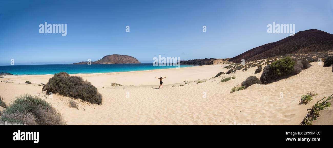 The panoramic view of Playa de las Conchas beach in Spain Stock Photo ...