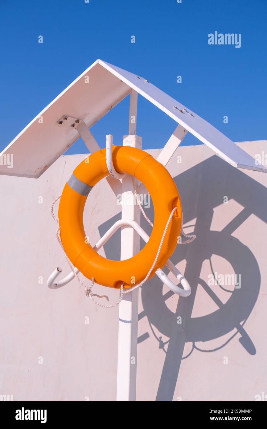 Orange lifebuoy on beach by sea. Safety equipment for rescuing people ...