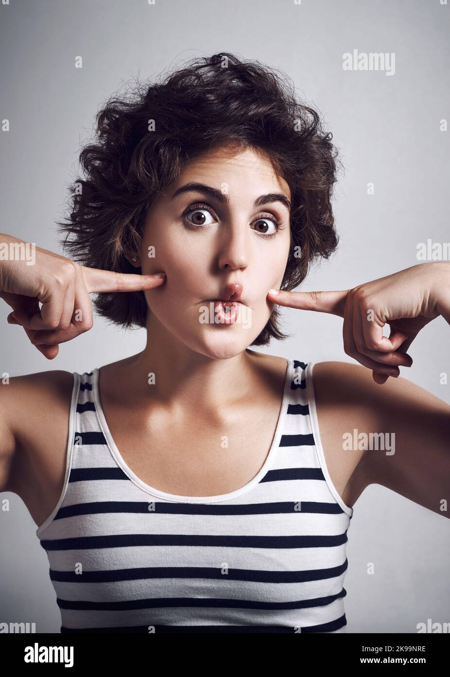 Youre all the humour you need. Studio portrait of an attractive young ...