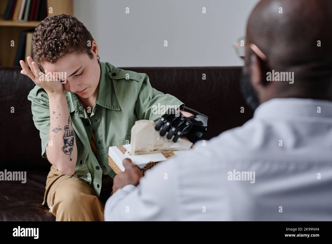 Young woman with disability crying during psychotherapy session while ...