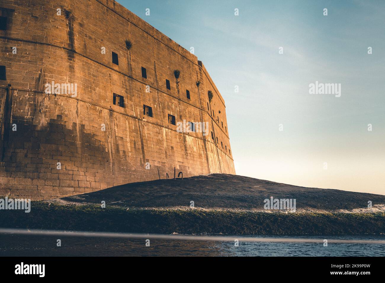 An aerial view of military base in sea under blue bright sky in Rio de ...