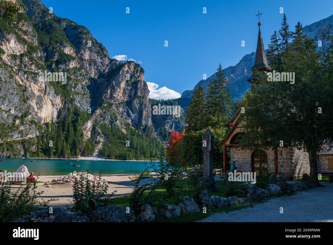 A beautiful shot of church towers near rocky mountains over Lago Di ...